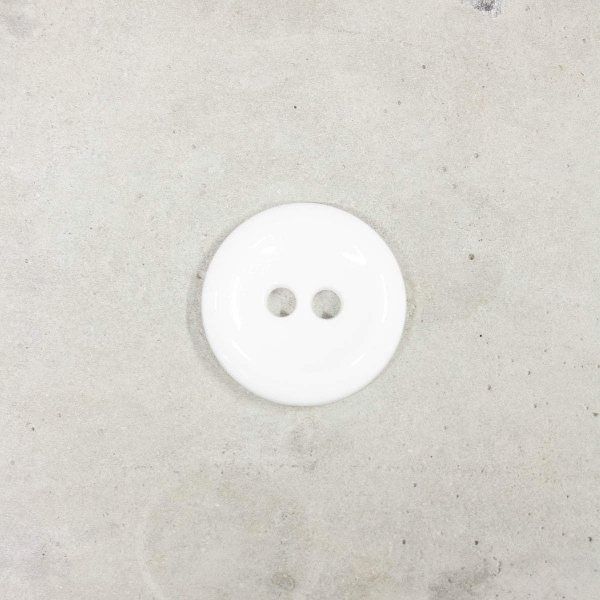 Off White Plastic 2-Hole Button 28mm | THE FABRIC SALES